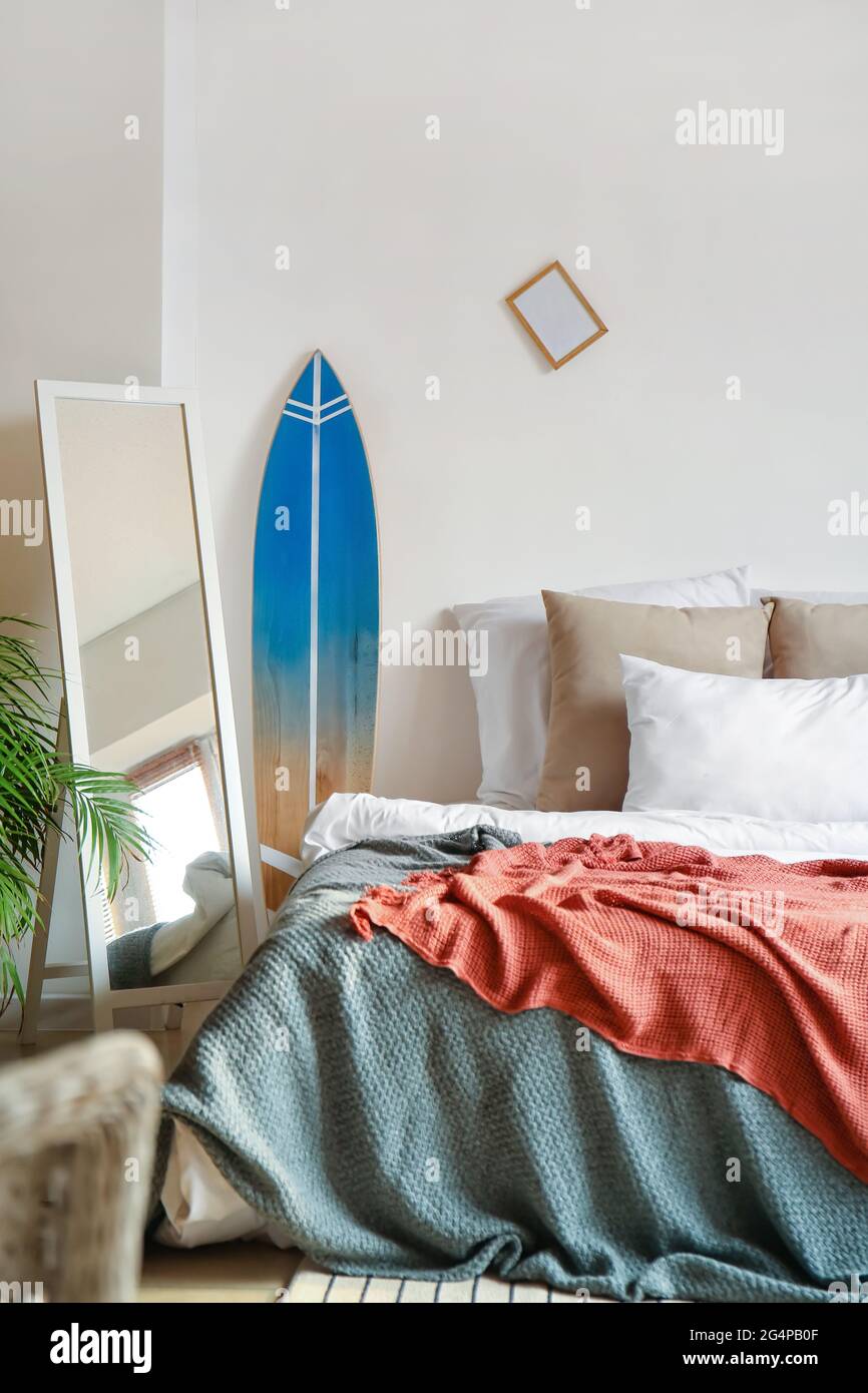 Interior of modern bedroom with surfboard Stock Photo - Alamy