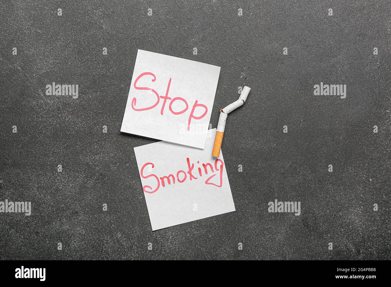 Broken cigarette and text NO SMOKING on dark background Stock Photo - Alamy