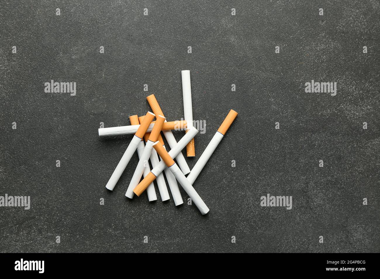 Many cigarettes on dark background Stock Photo - Alamy
