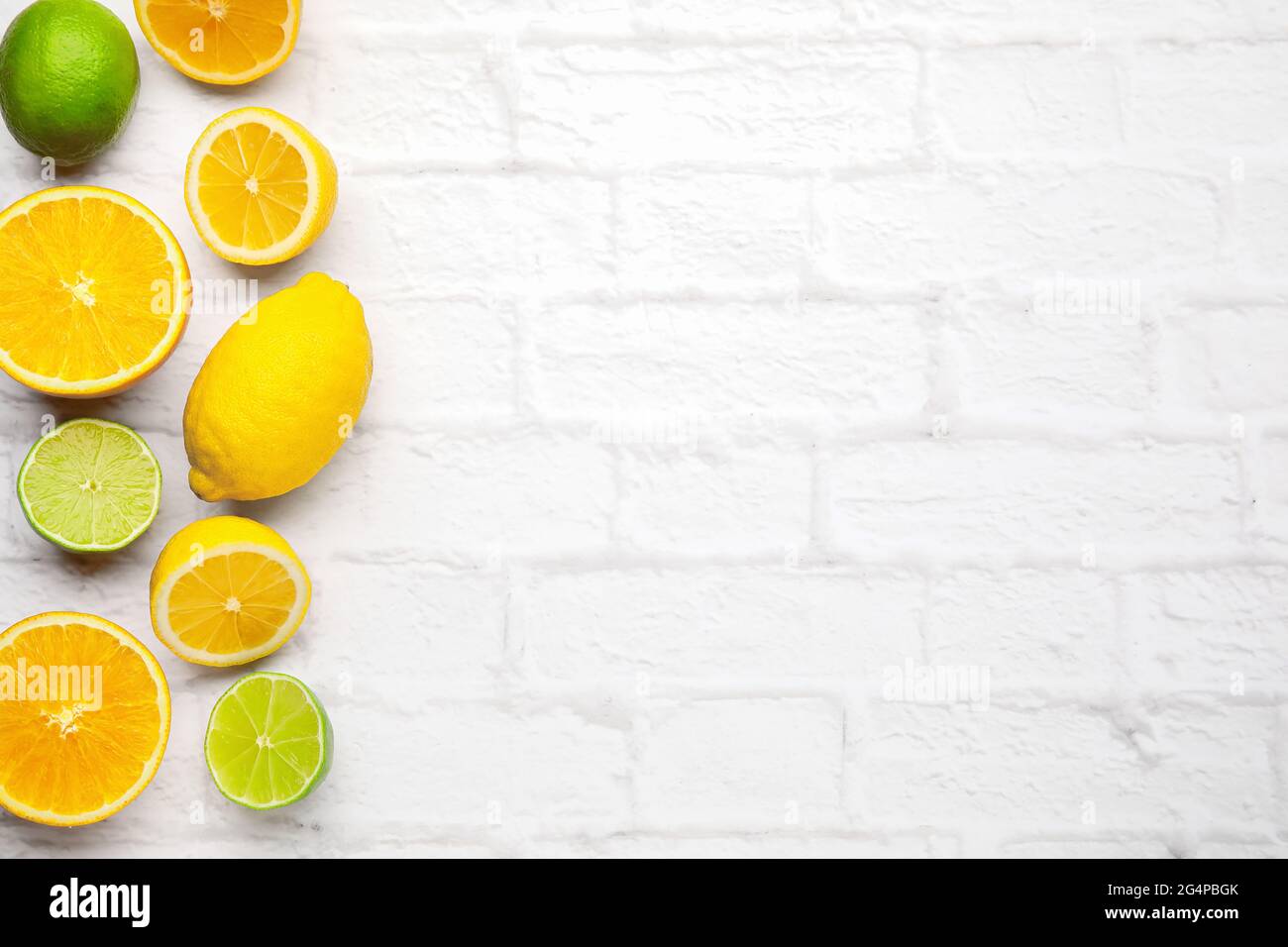 Healthy citrus fruits on brick background Stock Photo - Alamy