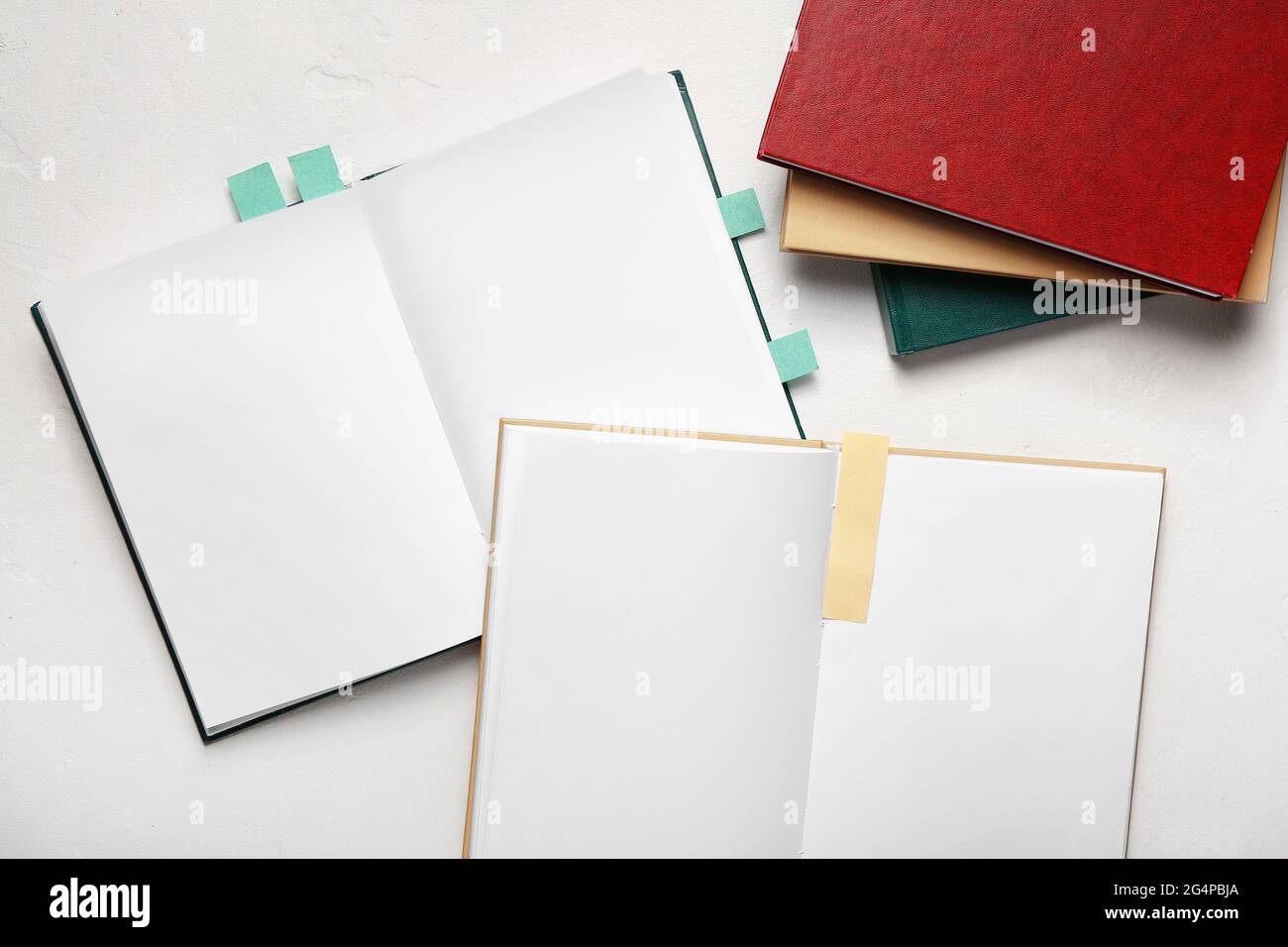 Books with bookmarks on white background Stock Photo - Alamy