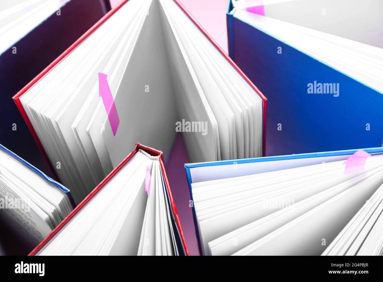 Books with bookmarks on color background Stock Photo - Alamy