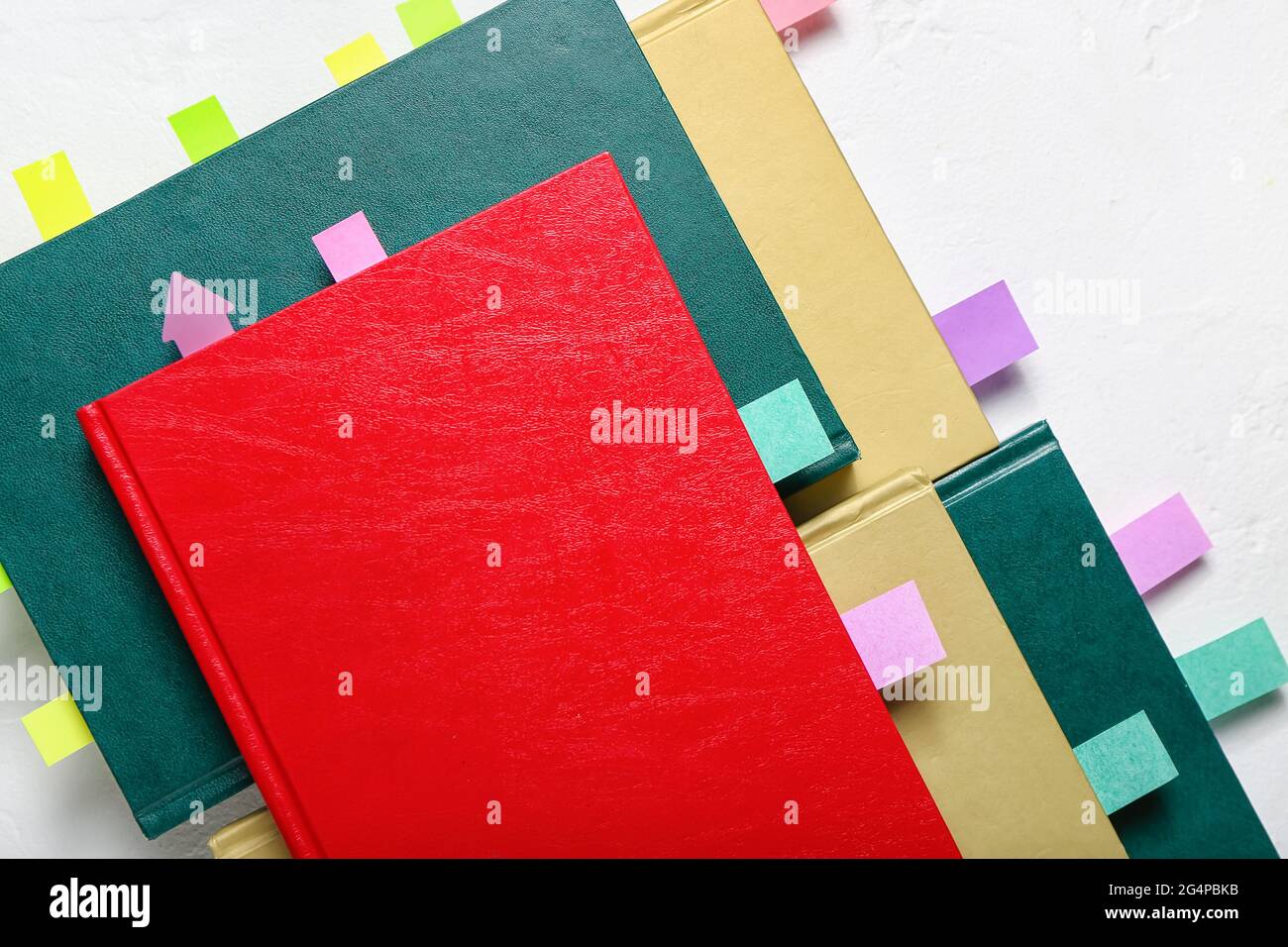 Books with bookmarks on white background Stock Photo - Alamy
