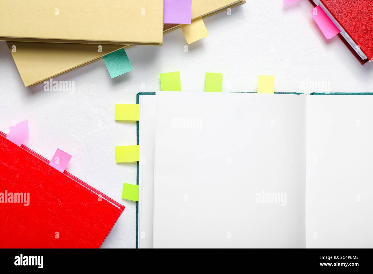 Books with bookmarks on white background Stock Photo - Alamy