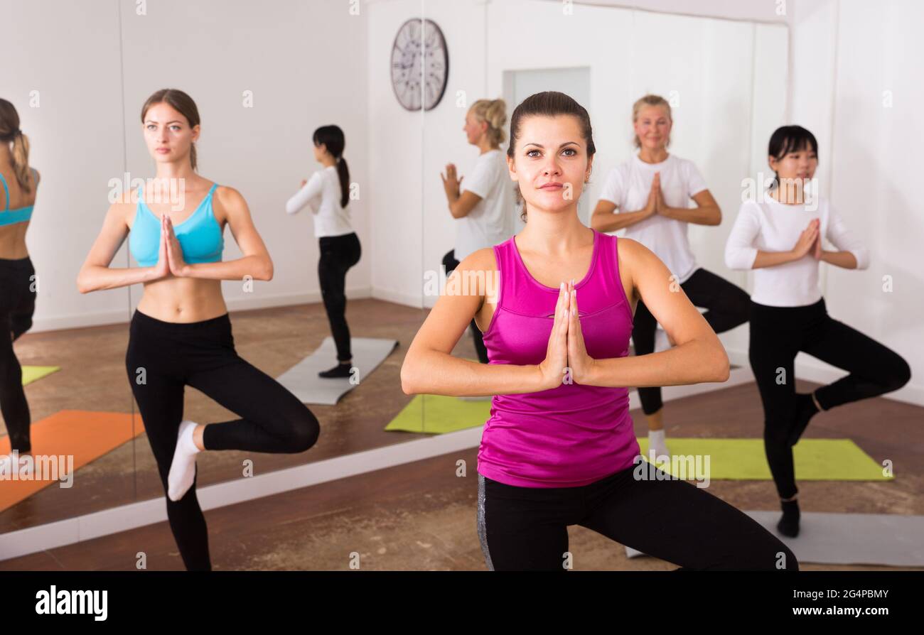 Women exercising yoga poses in fitness center Stock Photo - Alamy