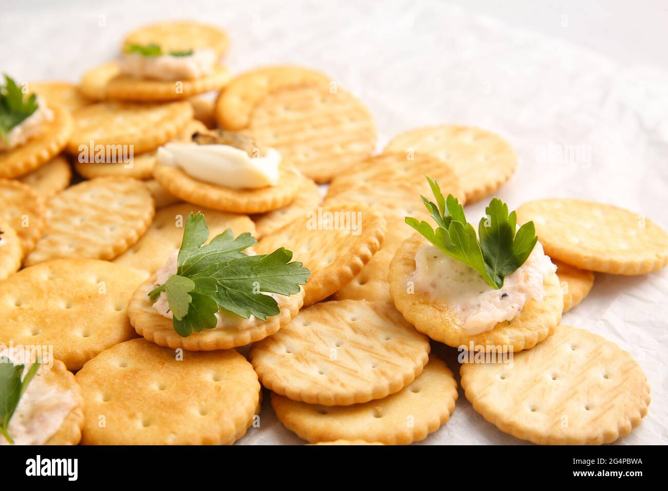Tasty crackers on baking parchment, closeup Stock Photo - Alamy