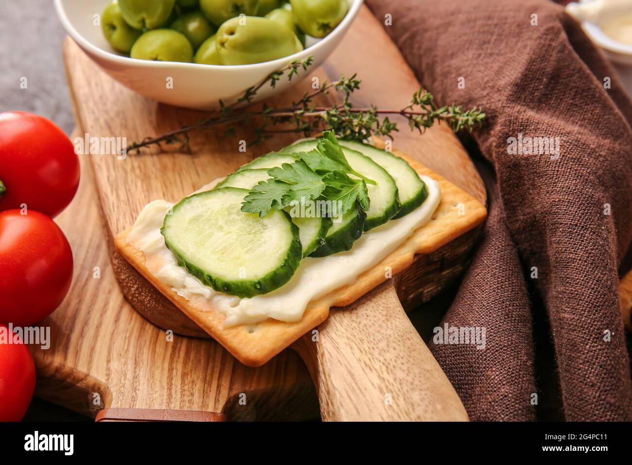 Tasty cracker with cheese and cucumber on table Stock Photo - Alamy