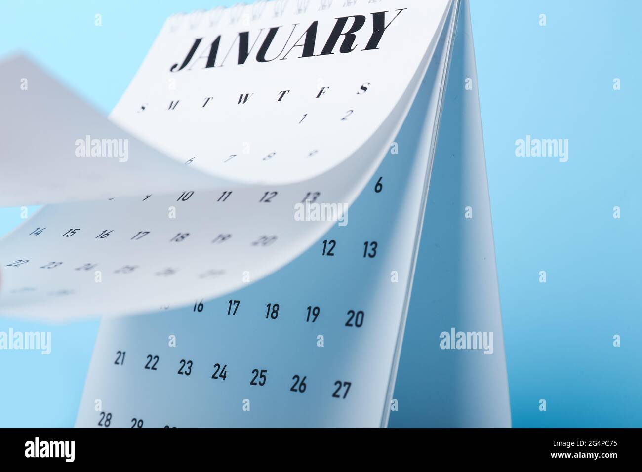 Flip calendar with page of January on color background, closeup Stock ...