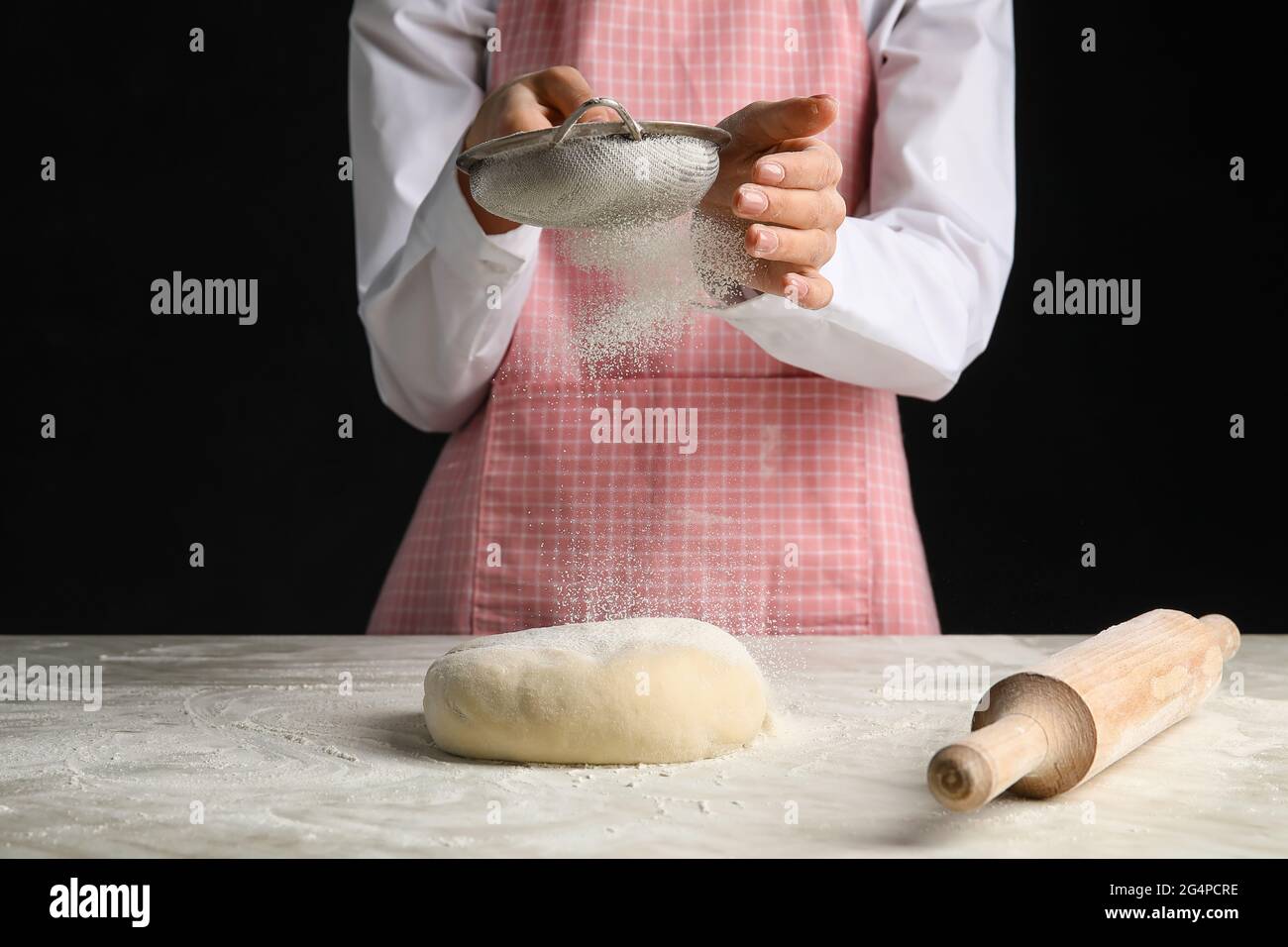 Female baker sieving flour hi-res stock photography and images - Alamy