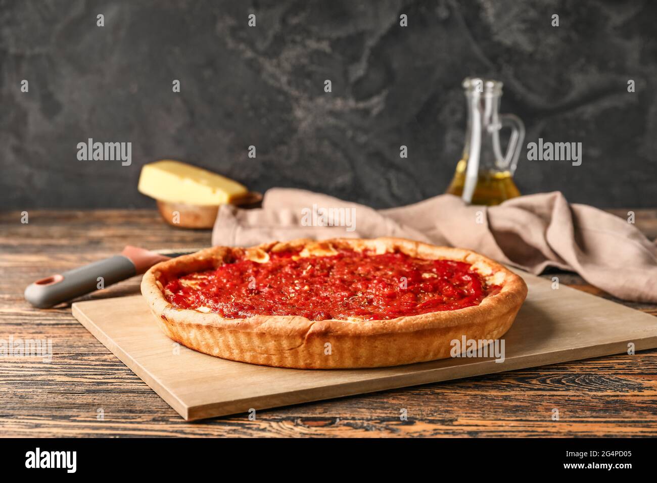 Board with tasty Chicago-style pizza on dark background Stock Photo - Alamy