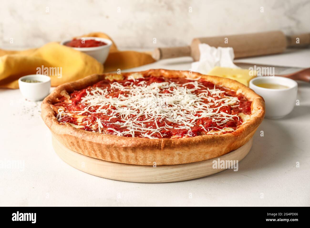 Tasty Chicago-style pizza and ingredients on light background Stock ...