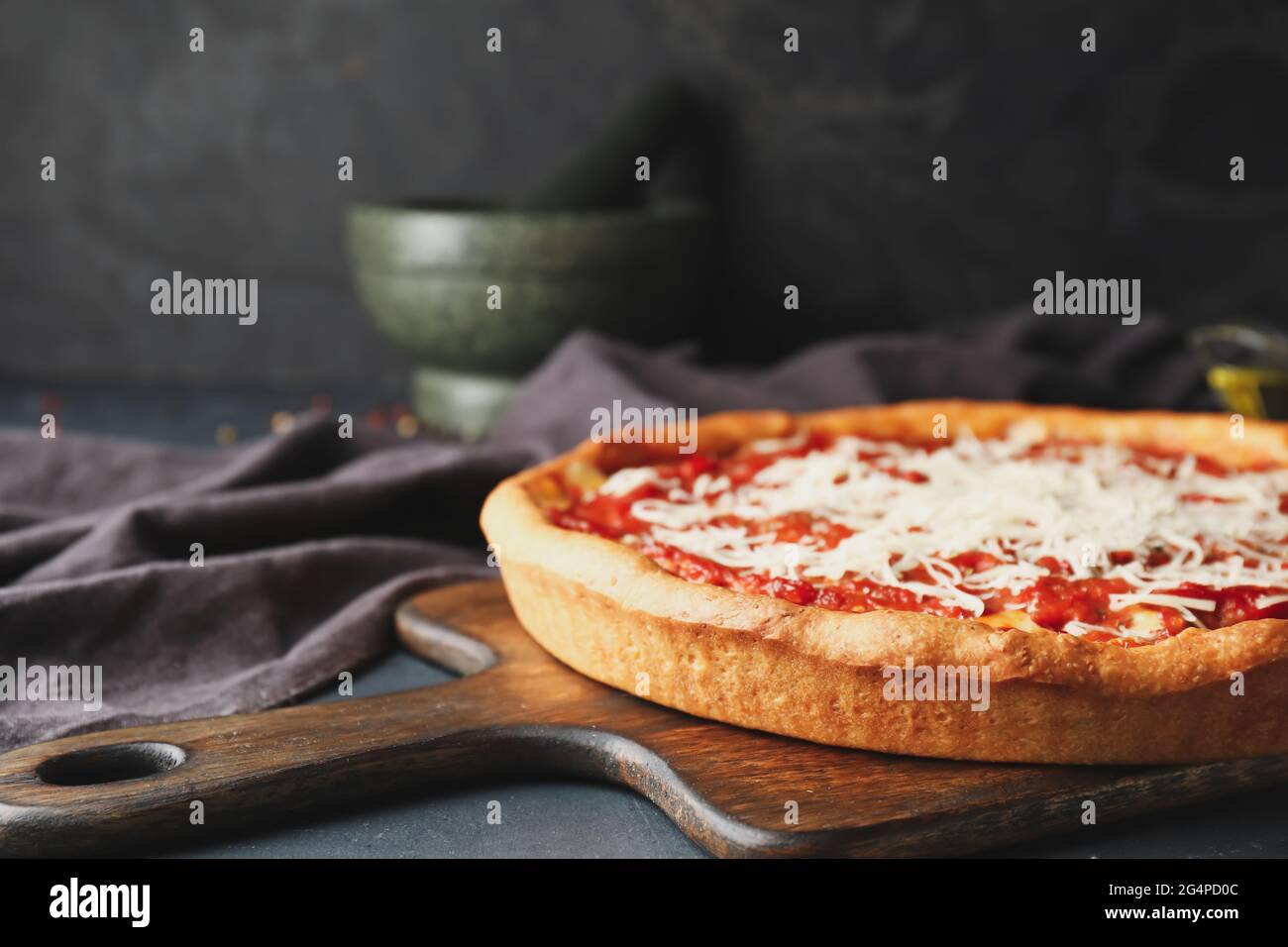 Board with tasty Chicago-style pizza on dark background Stock Photo - Alamy