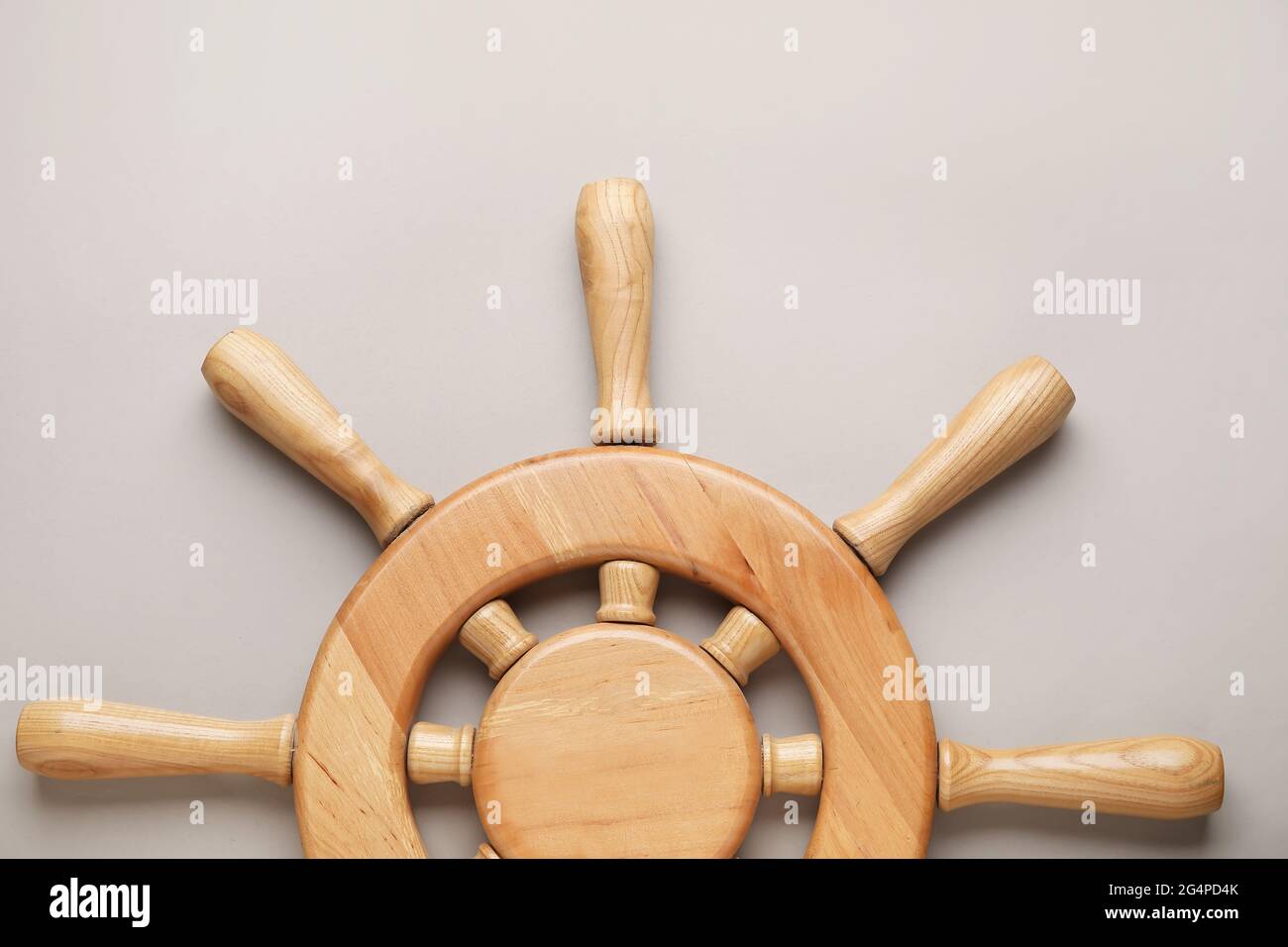 Ship helm on grey background Stock Photo - Alamy