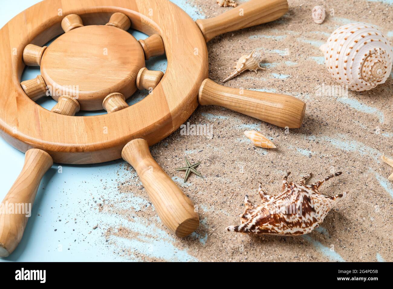 Helm, sand and sea shells on color background Stock Photo - Alamy