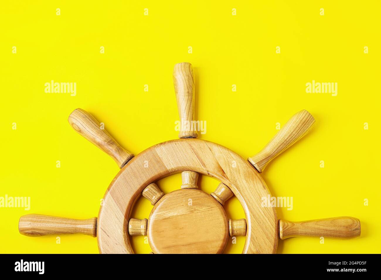 Ship helm on color background Stock Photo - Alamy