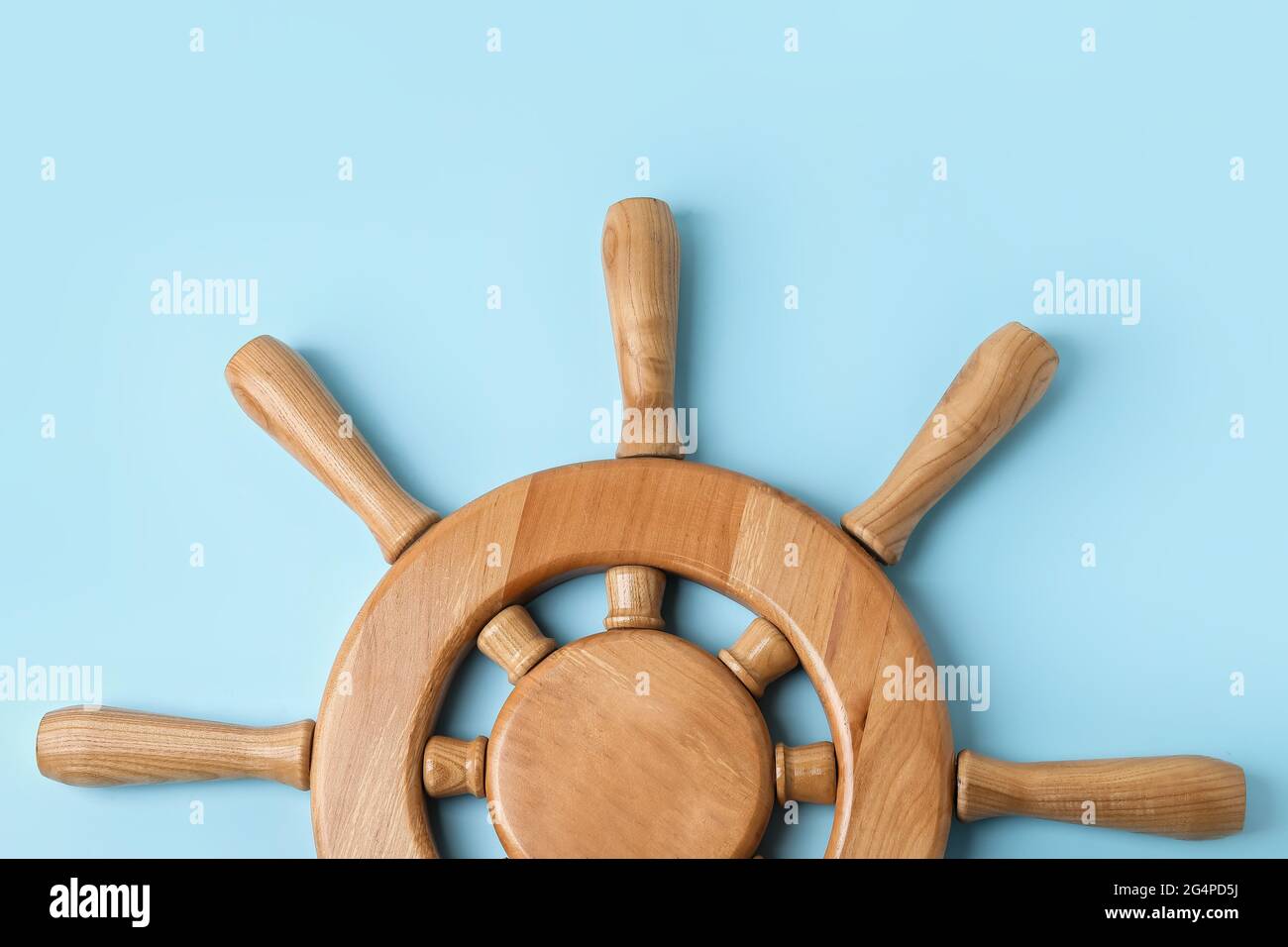 Ship helm on color background Stock Photo - Alamy