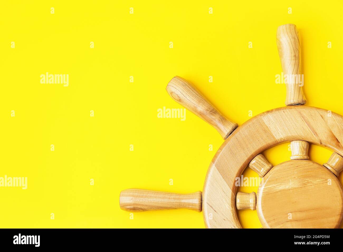 Ship helm on color background Stock Photo - Alamy