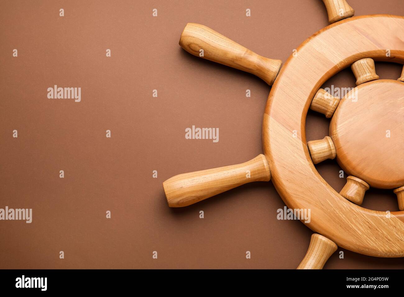 Ship helm on color background Stock Photo - Alamy