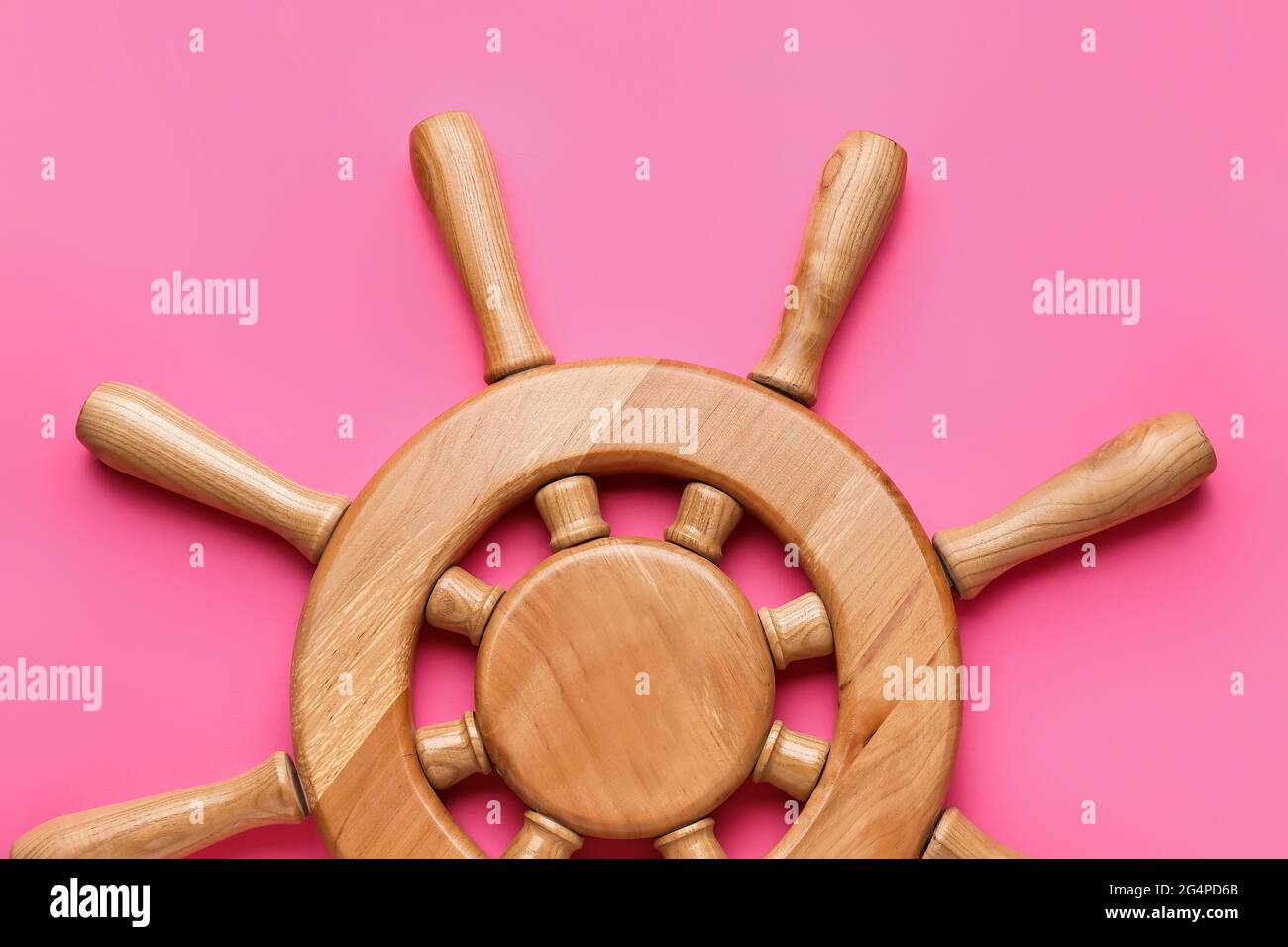 Ship helm on color background Stock Photo - Alamy