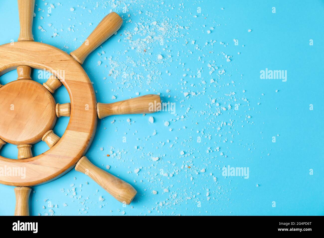 Ship helm on color background Stock Photo - Alamy