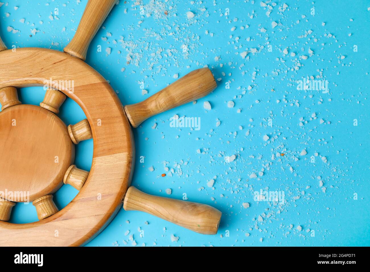 Ship helm on color background Stock Photo - Alamy
