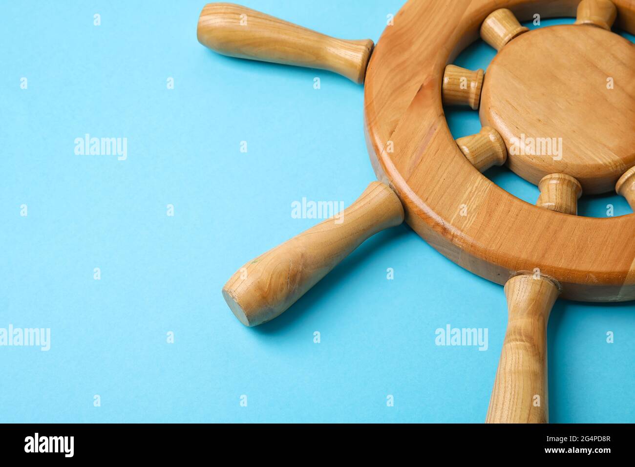 Ship helm on color background Stock Photo - Alamy