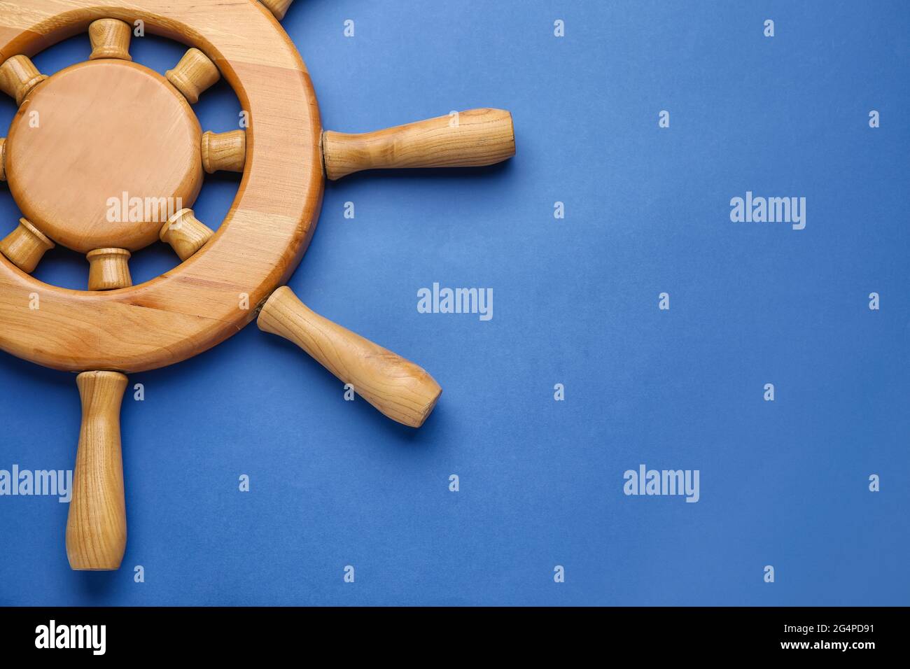 Ship helm on color background Stock Photo - Alamy