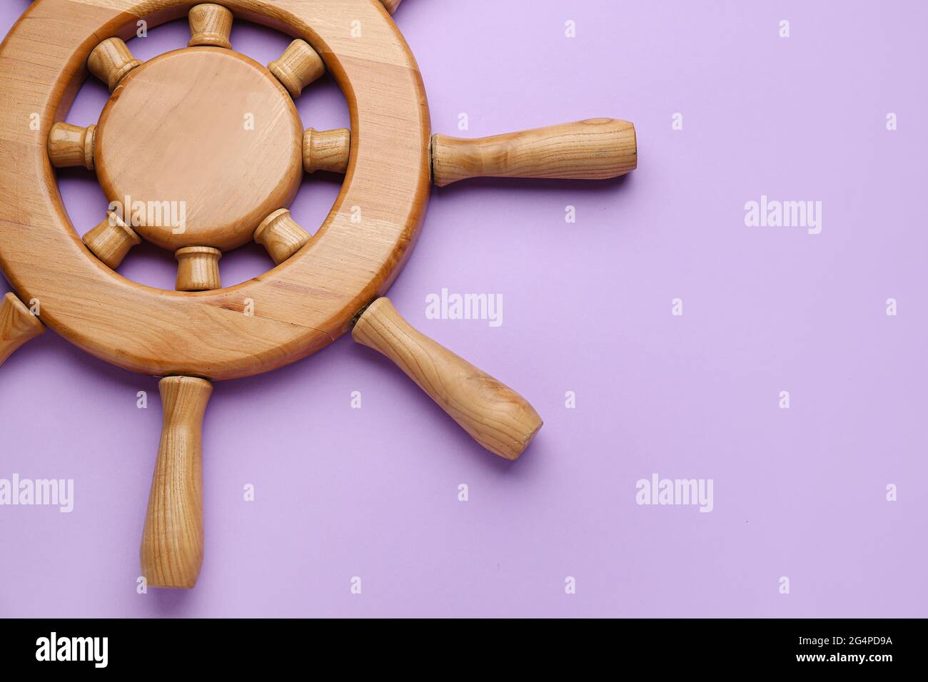 Ship helm on color background Stock Photo - Alamy