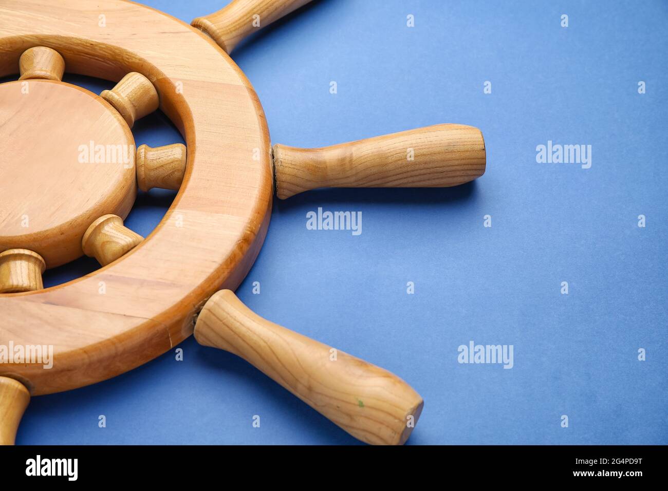 Ship helm on color background Stock Photo - Alamy