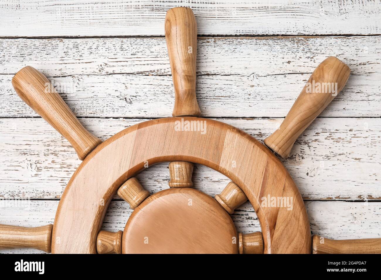 Ship helm on wooden background Stock Photo - Alamy