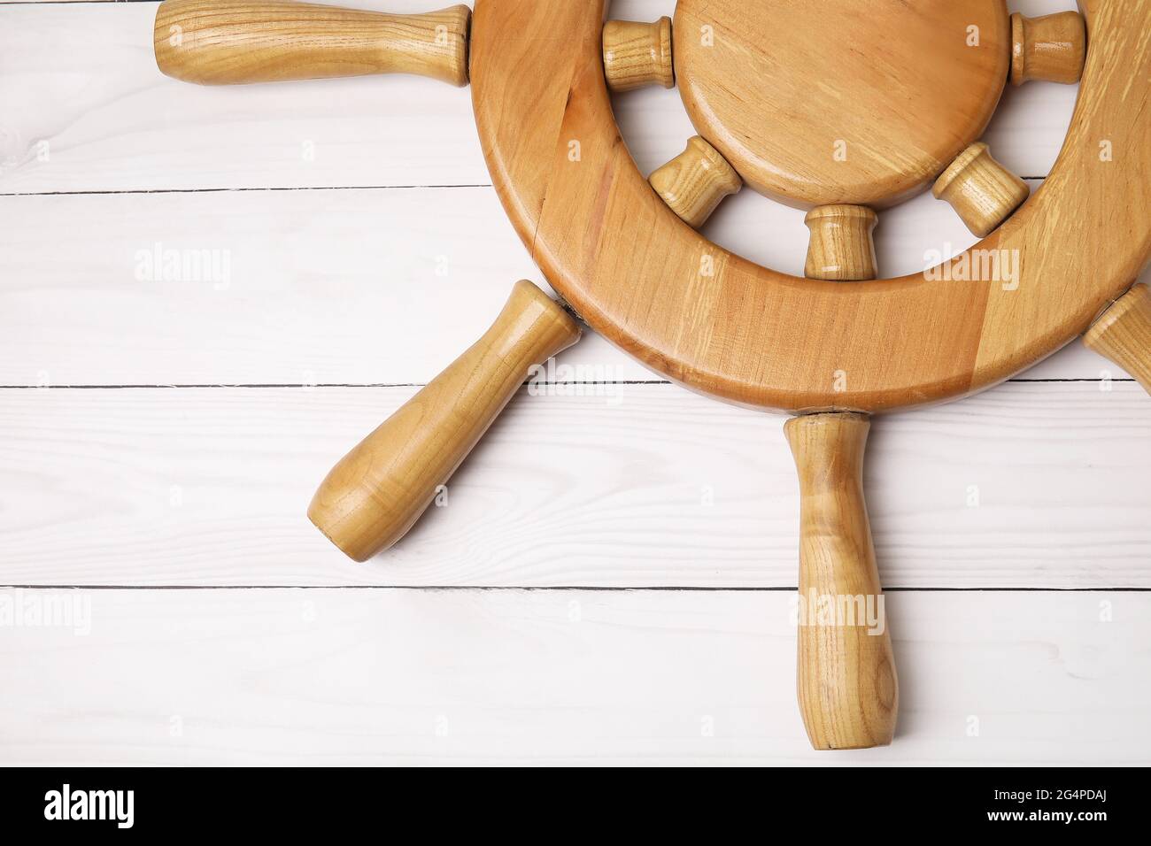 Ship helm on white wooden background Stock Photo - Alamy