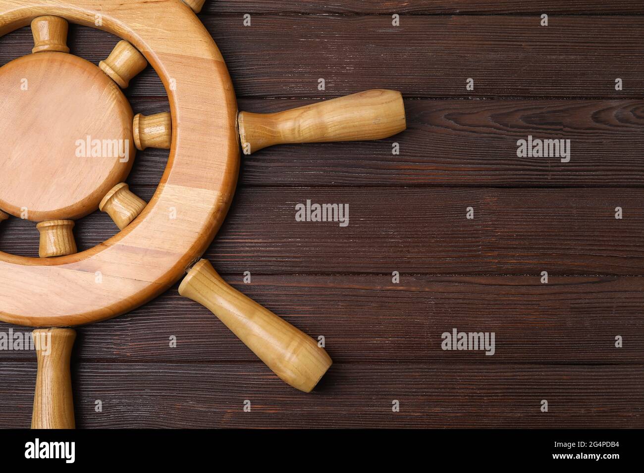 Ship helm on wooden background Stock Photo - Alamy