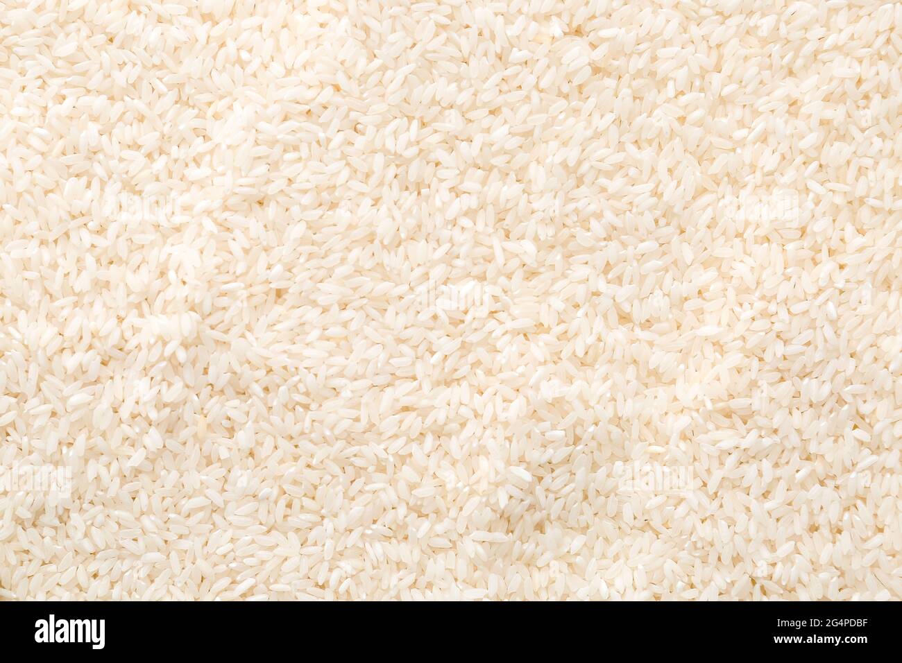 Raw rice as background, closeup Stock Photo - Alamy