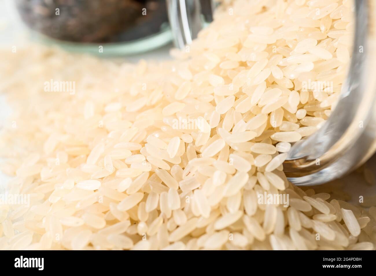 Overturned jar with raw rice, closeup Stock Photo - Alamy