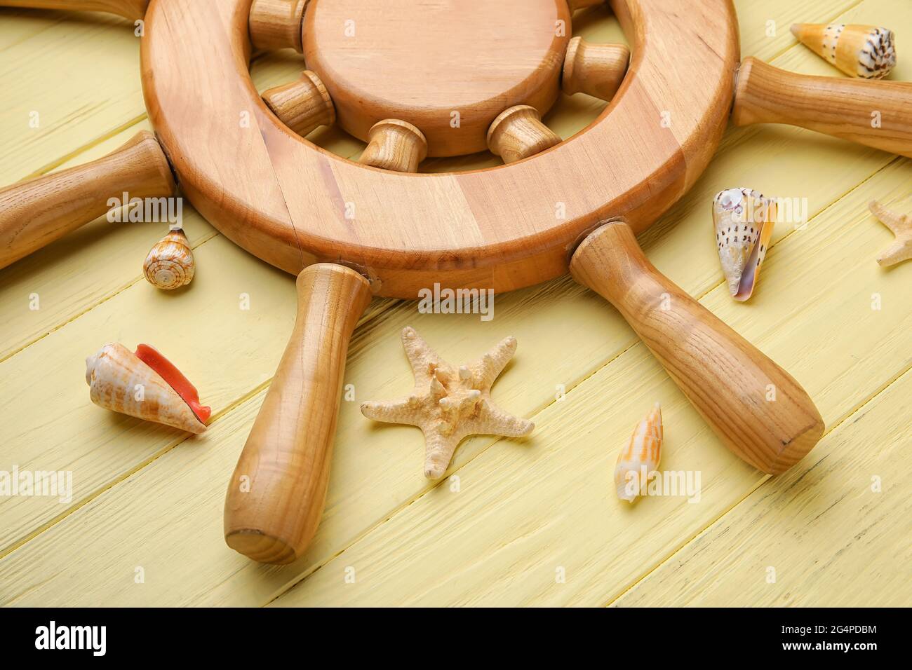 Helm and sea shells on wooden background Stock Photo - Alamy