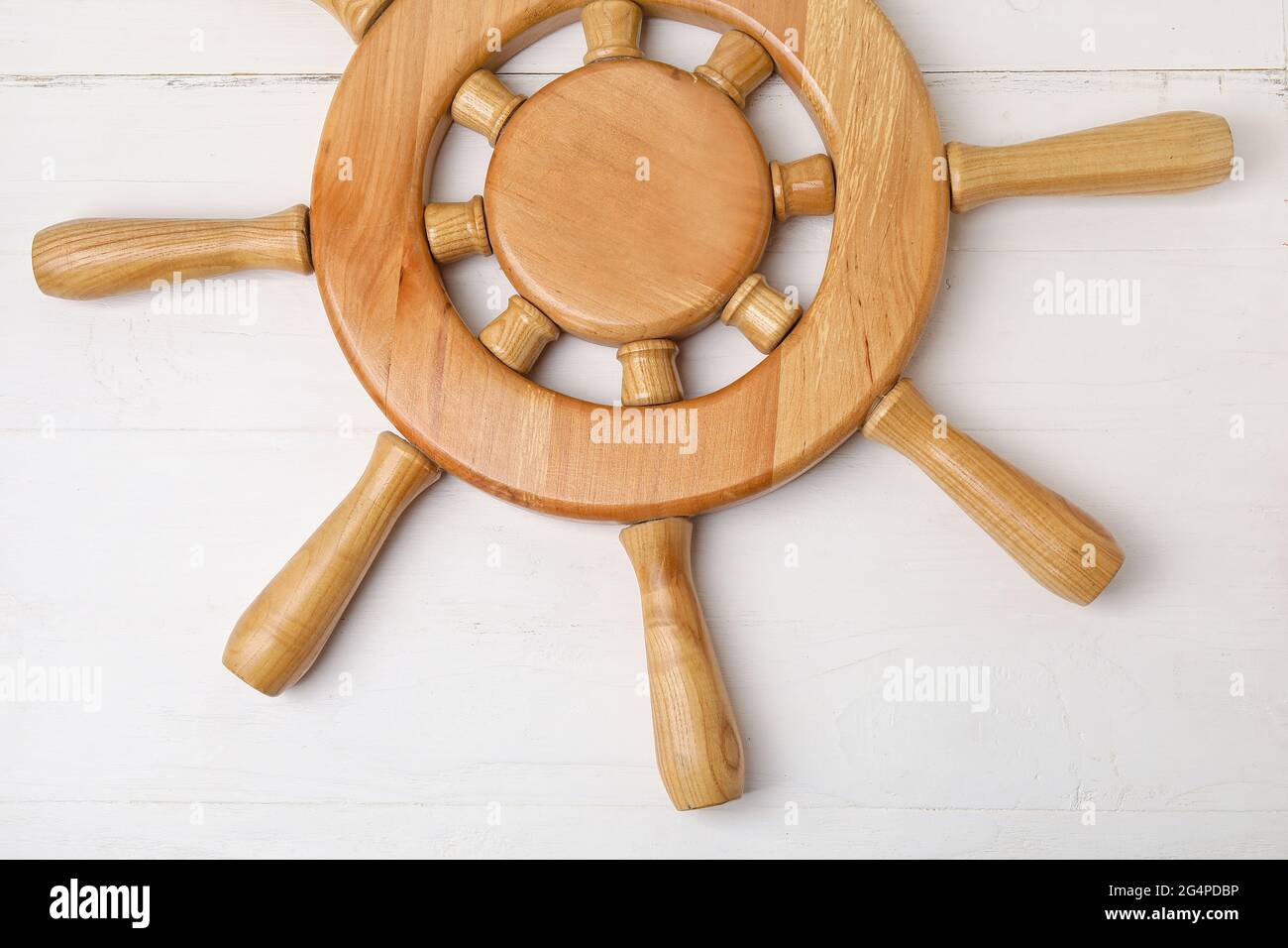 Ship helm on white wooden background Stock Photo - Alamy