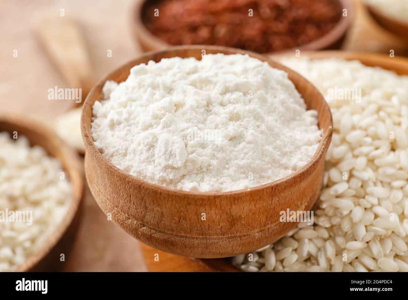 Different types of raw rice and flour on color background, closeup ...