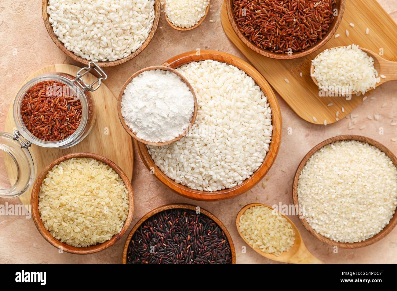 Different types of raw rice and flour on color background Stock Photo ...