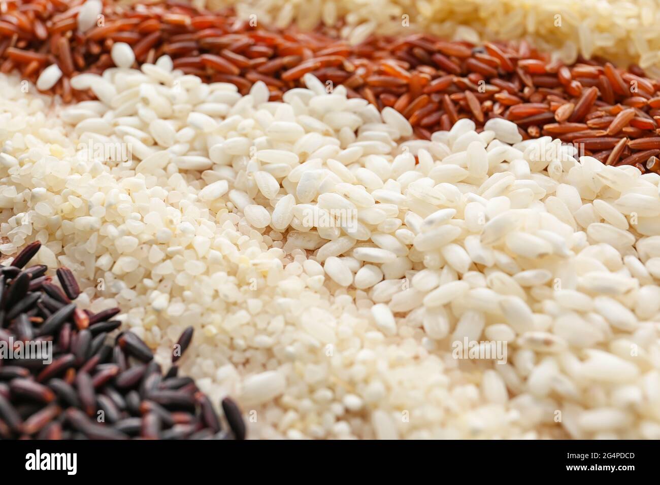 Different types of raw rice as background, closeup Stock Photo - Alamy