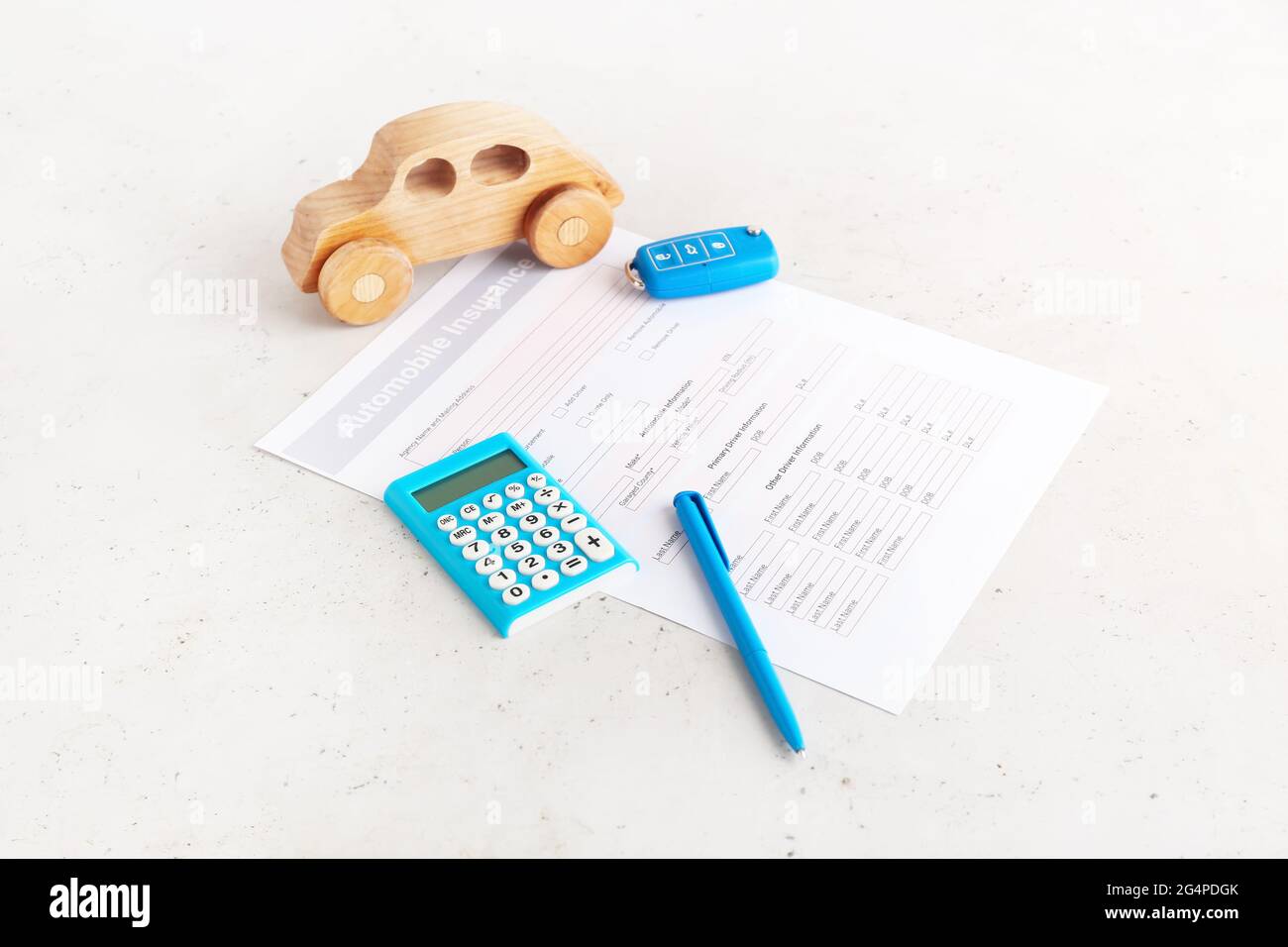 Automobile insurance with calculator and car figure on white background ...