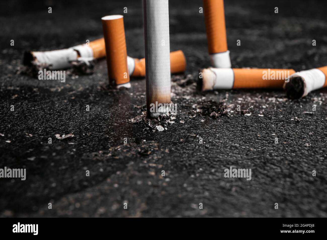Burnt cigarettes on dark background, closeup Stock Photo - Alamy