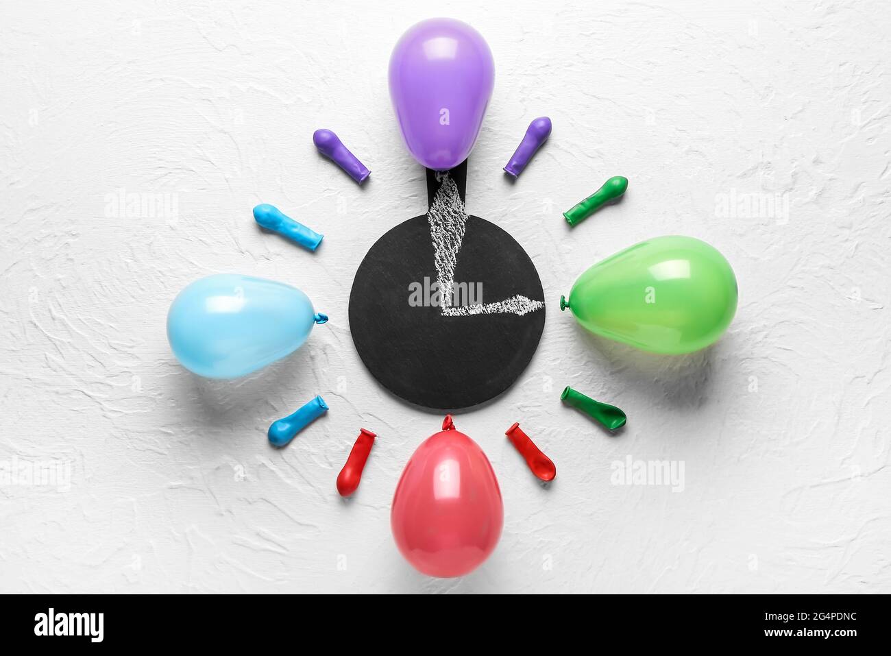 Creative clock made of air balloons on white background Stock Photo - Alamy