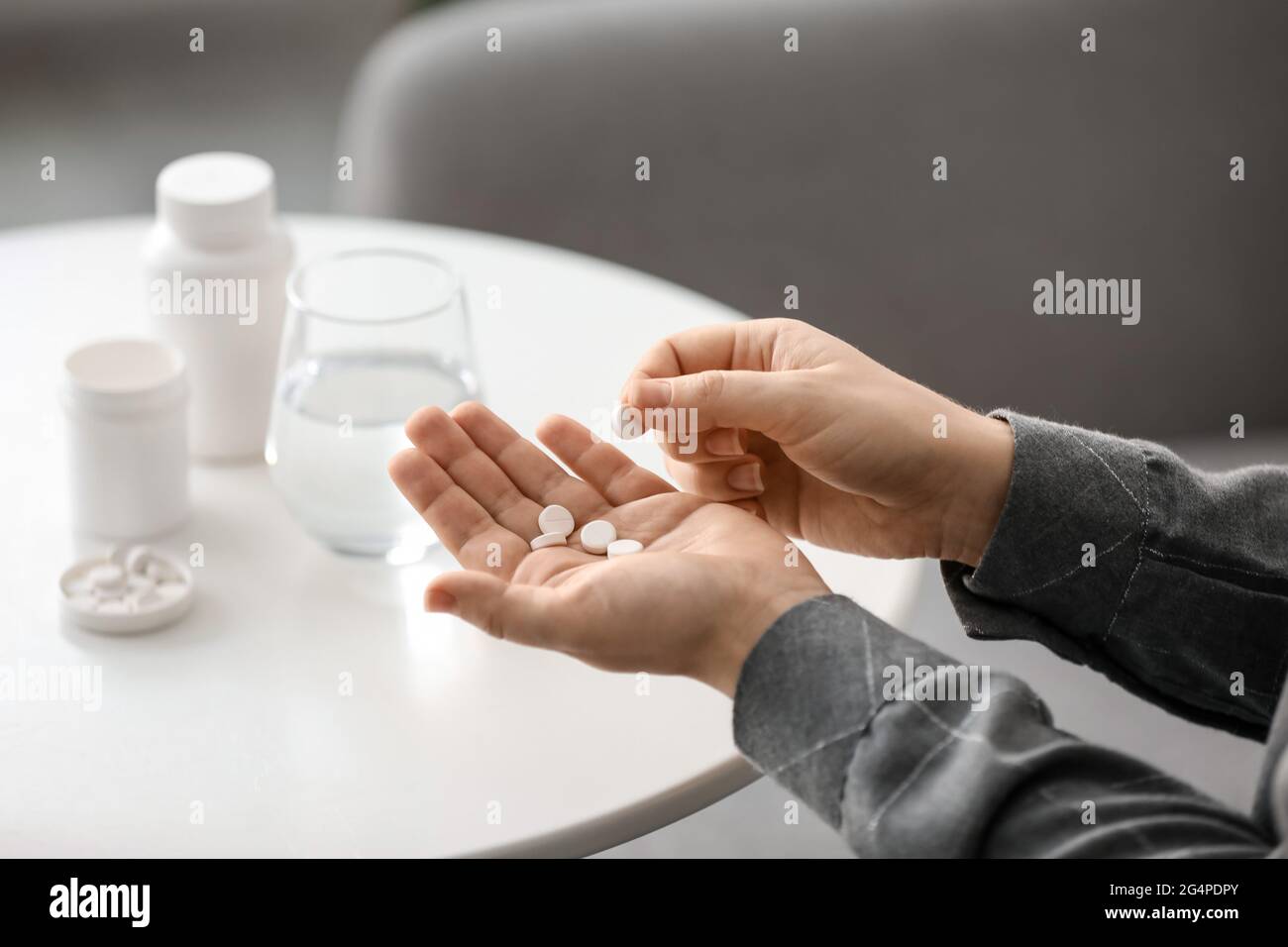 Woman taking pills at home, closeup Stock Photo - Alamy