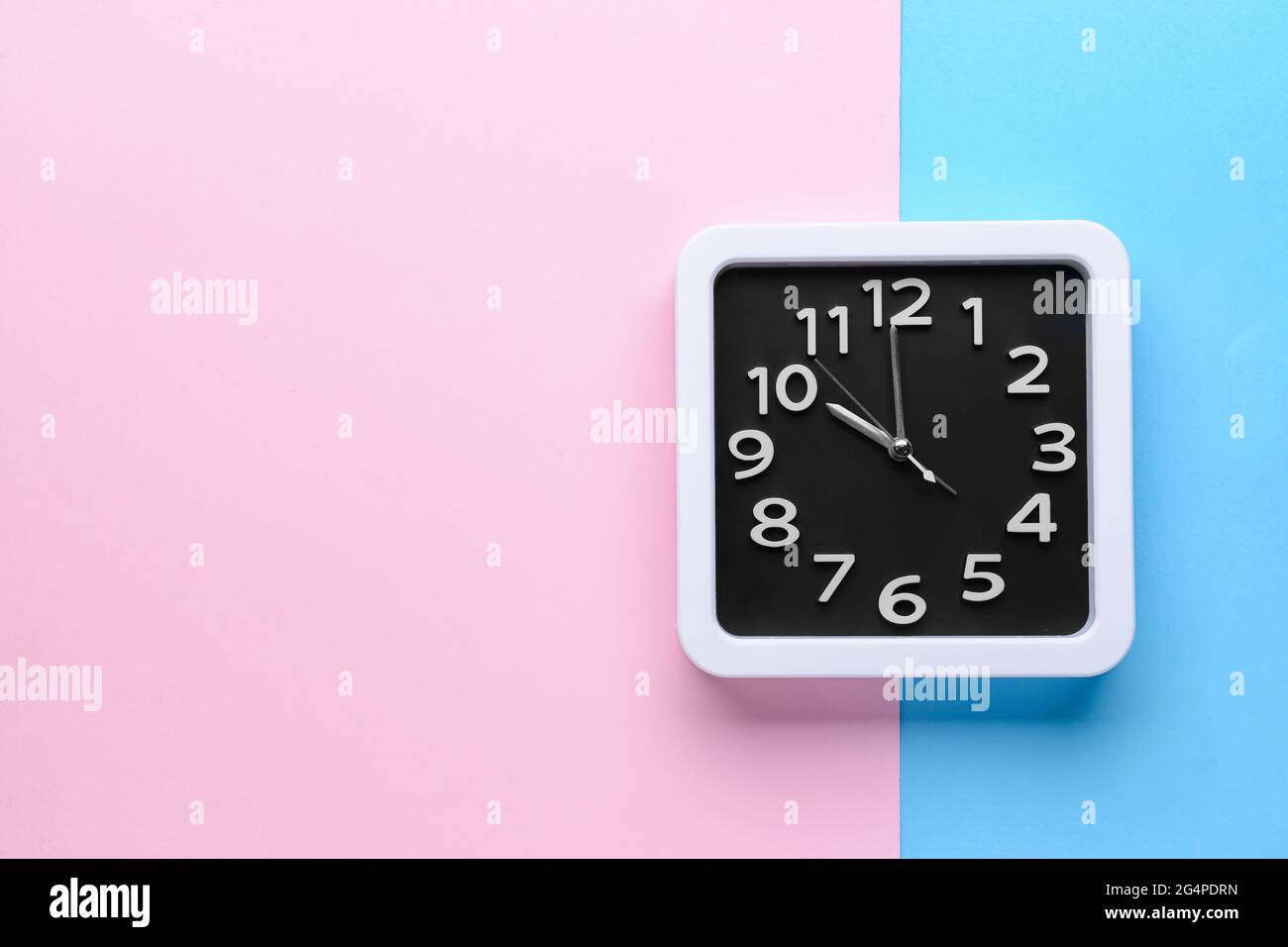 Stylish clock on color background Stock Photo - Alamy