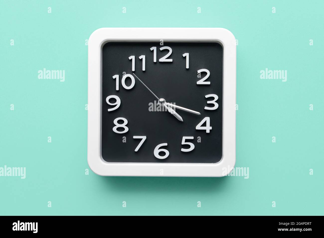 Stylish clock on color background Stock Photo - Alamy
