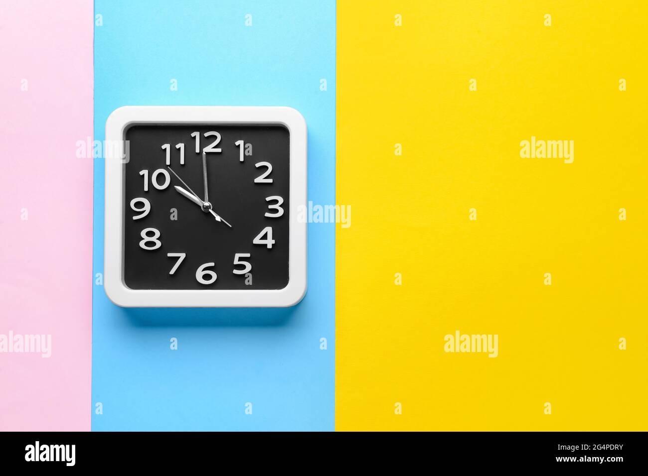 Stylish clock on color background Stock Photo - Alamy