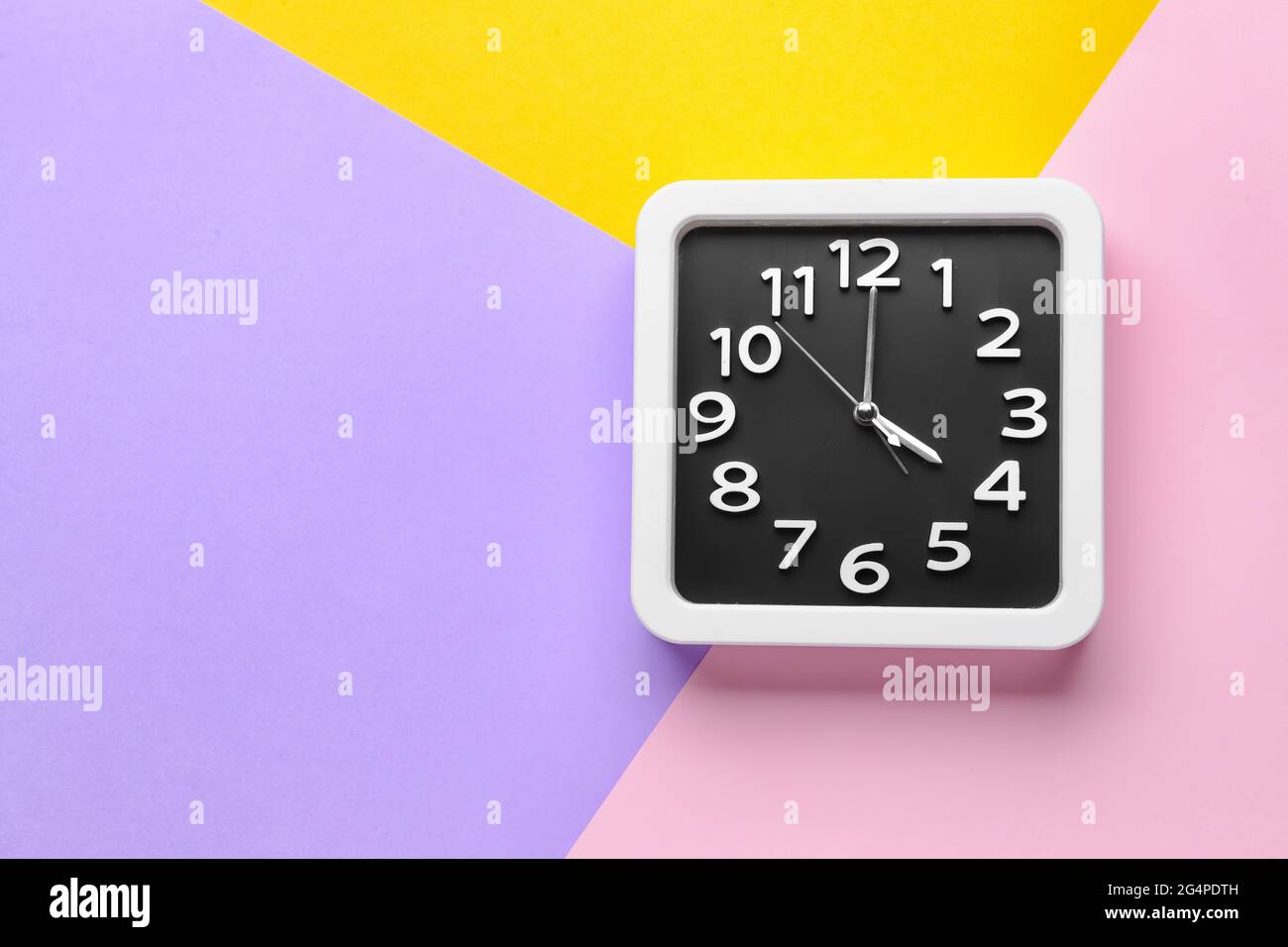 Stylish clock on color background Stock Photo - Alamy