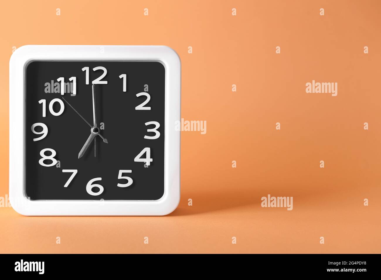 Stylish clock on color background Stock Photo - Alamy