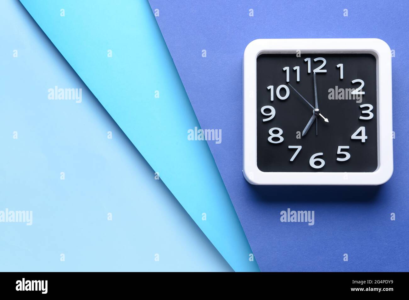 Stylish clock on color background Stock Photo - Alamy