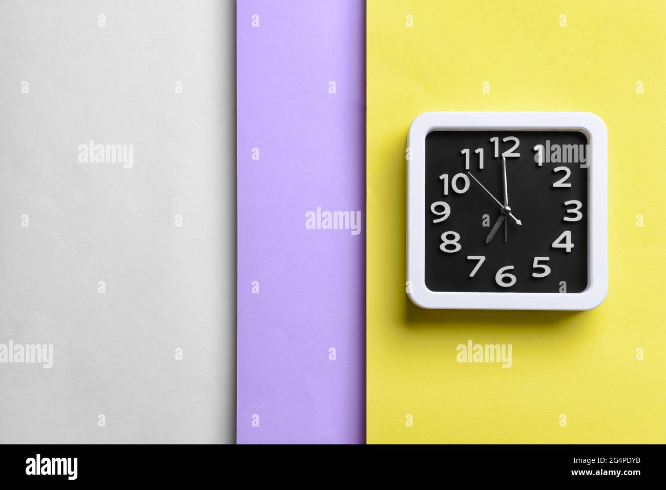 Stylish clock on color background Stock Photo - Alamy